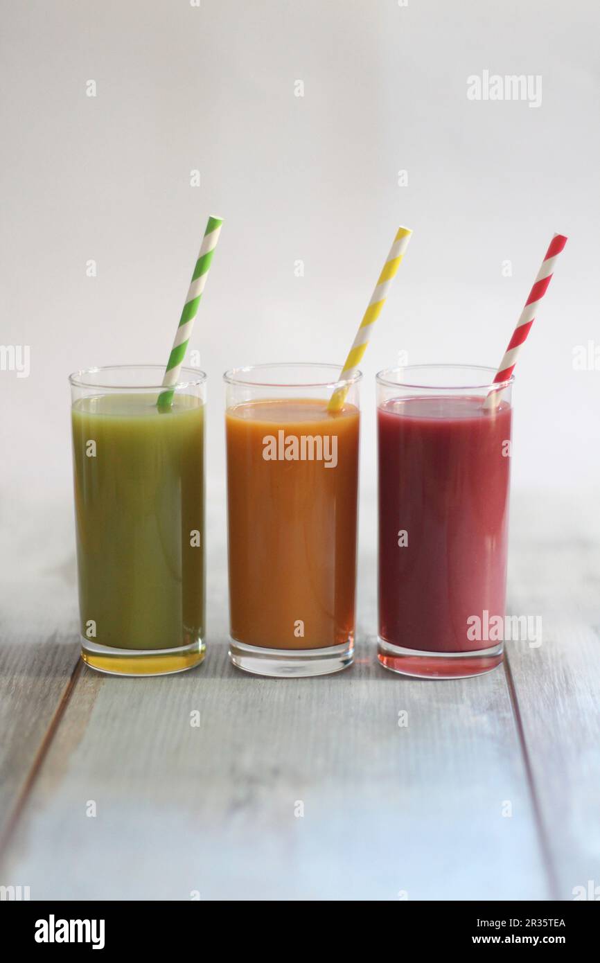 Three fruit and vegetable smoothies in different colours Stock Photo ...
