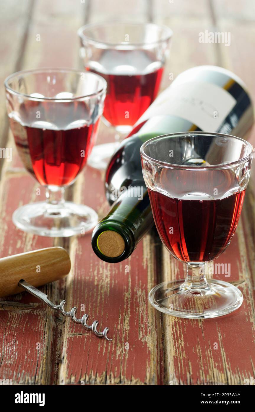 Three glasses of red wine and a bottle of red wine Stock Photo - Alamy