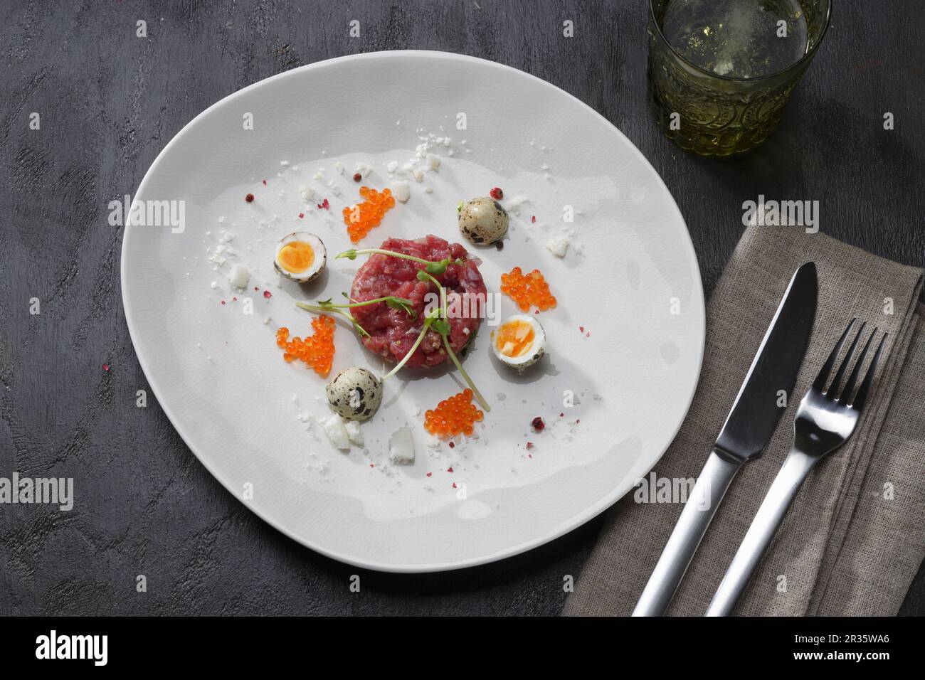 Beef tatar with quail's eggs and caviar Stock Photo - Alamy
