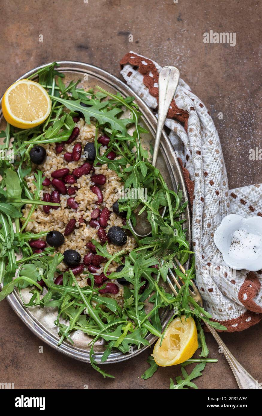 Lemon and wholemeal rice with beans, olives and rocket Stock Photo - Alamy