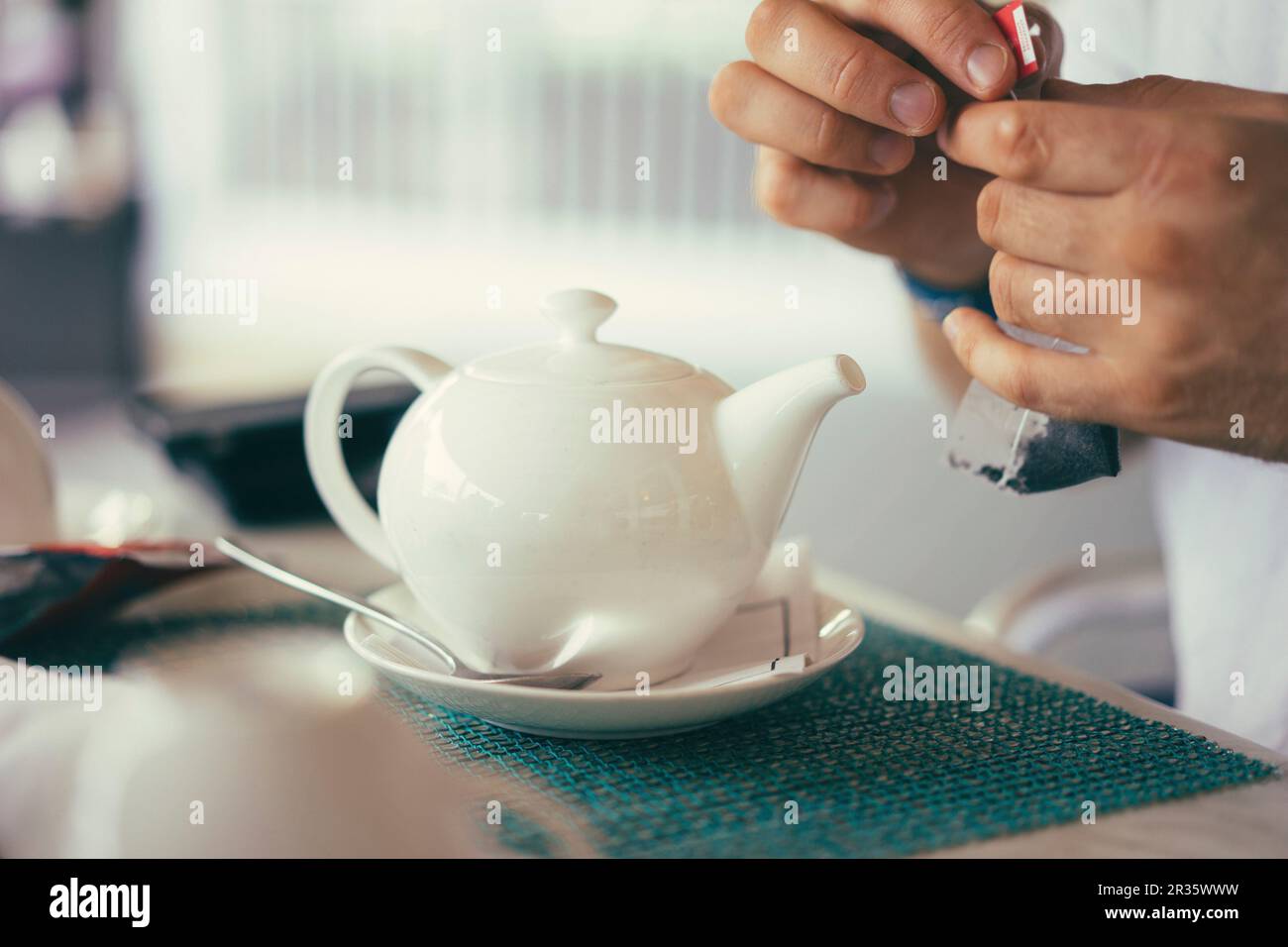 A white teapot in a restaurant Stock Photo - Alamy