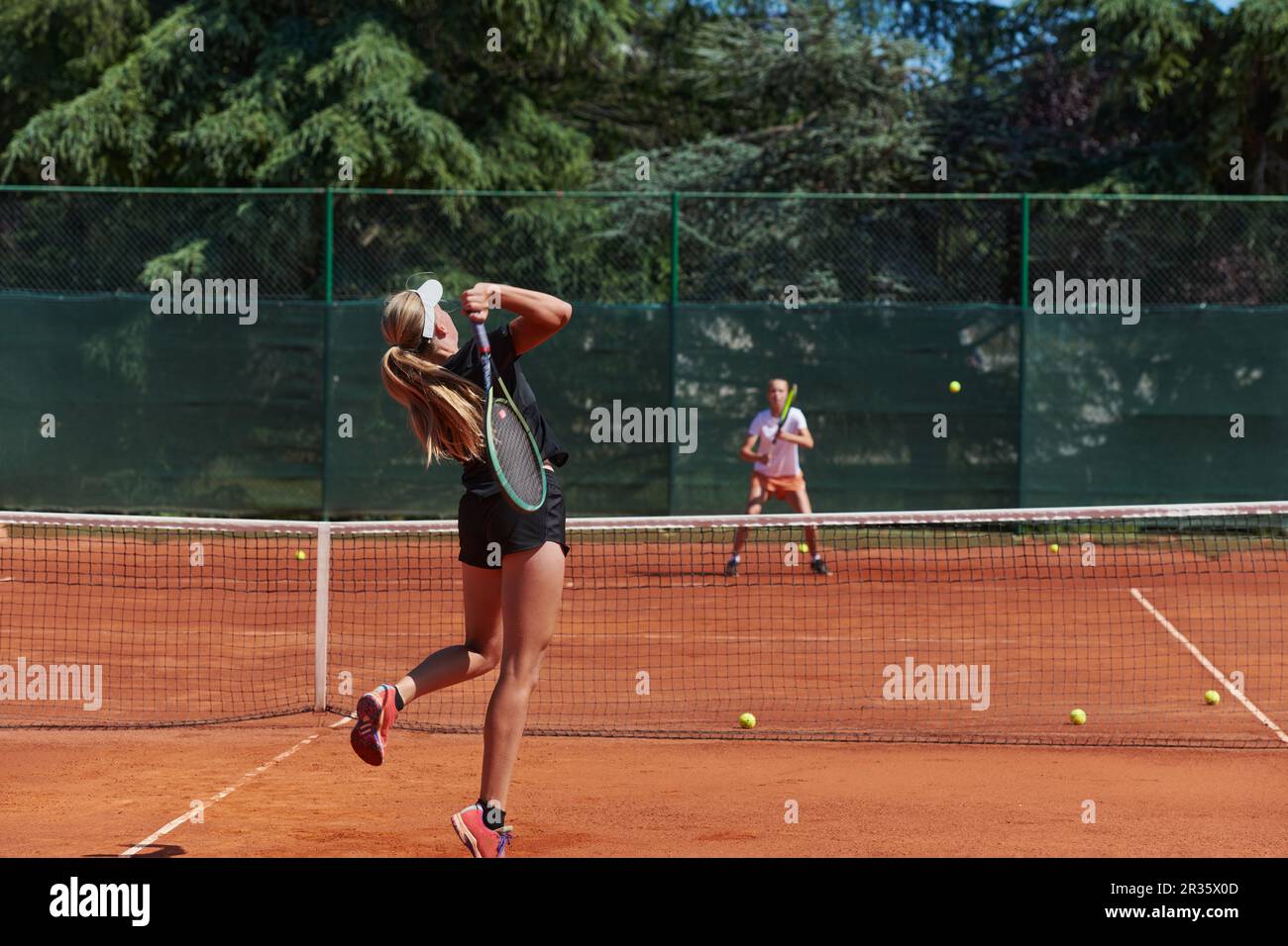 Two girls playing tennis on court hi-res stock photography and images ...
