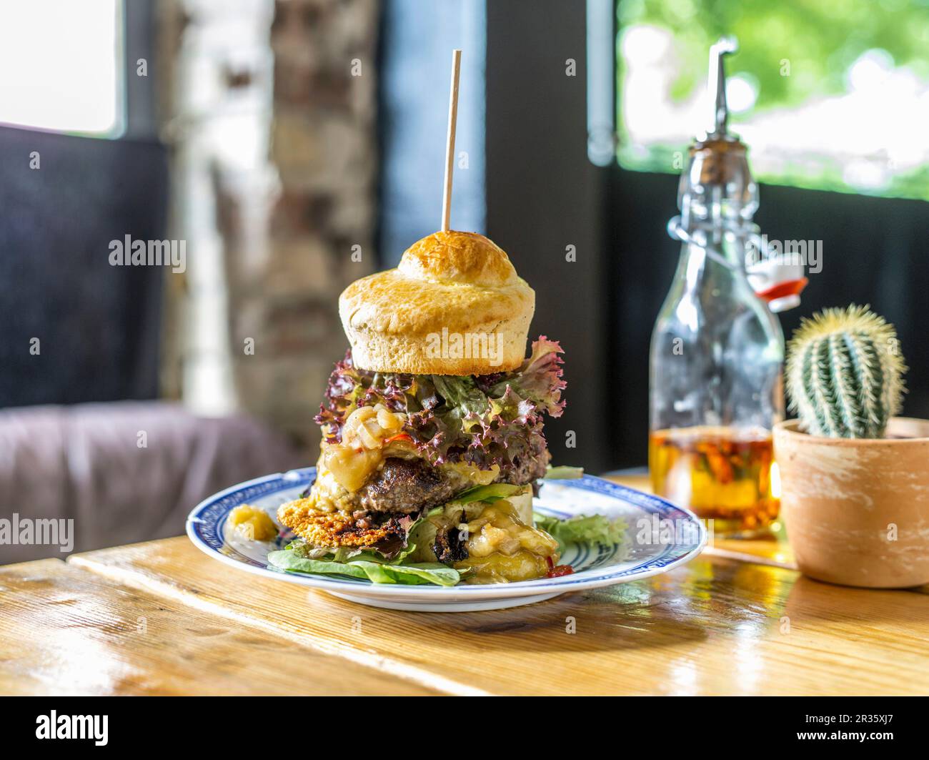 A pop-over burger in a restaurant Stock Photo - Alamy