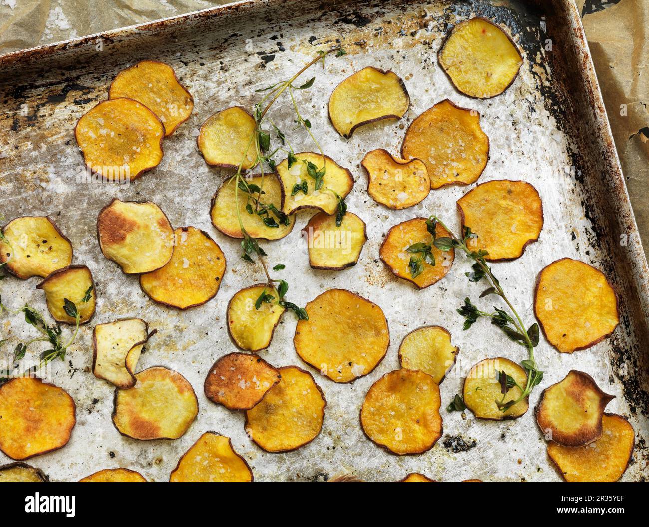 Sweet potato crisps on a baking tray Stock Photo - Alamy