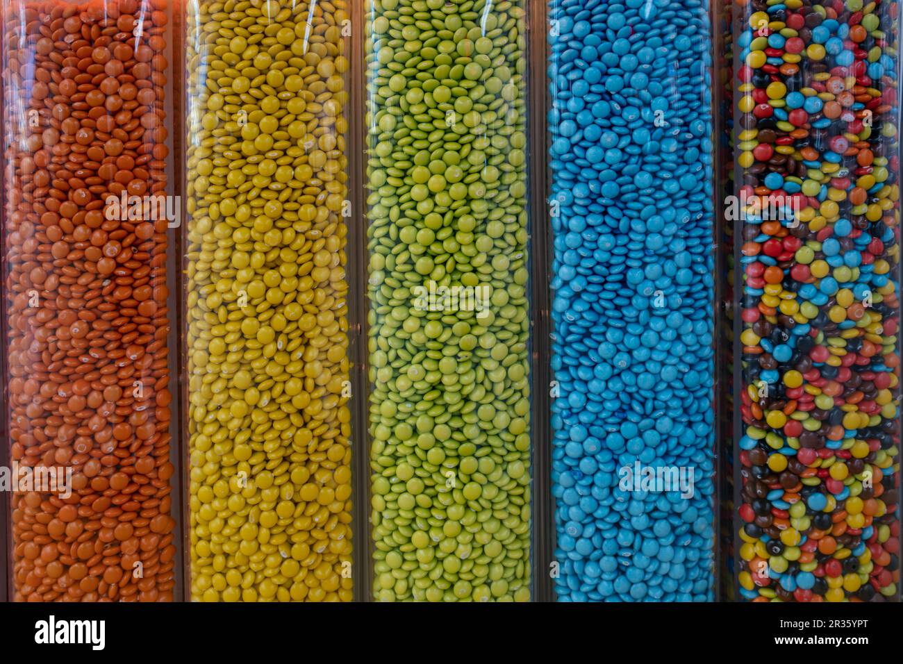 Front view of sugar dragee divided into colors. Orange, yellow, green ...