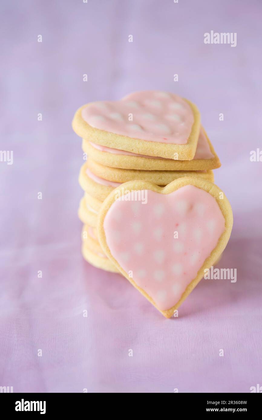 Heart-shaped biscuits with pink icing Stock Photo - Alamy