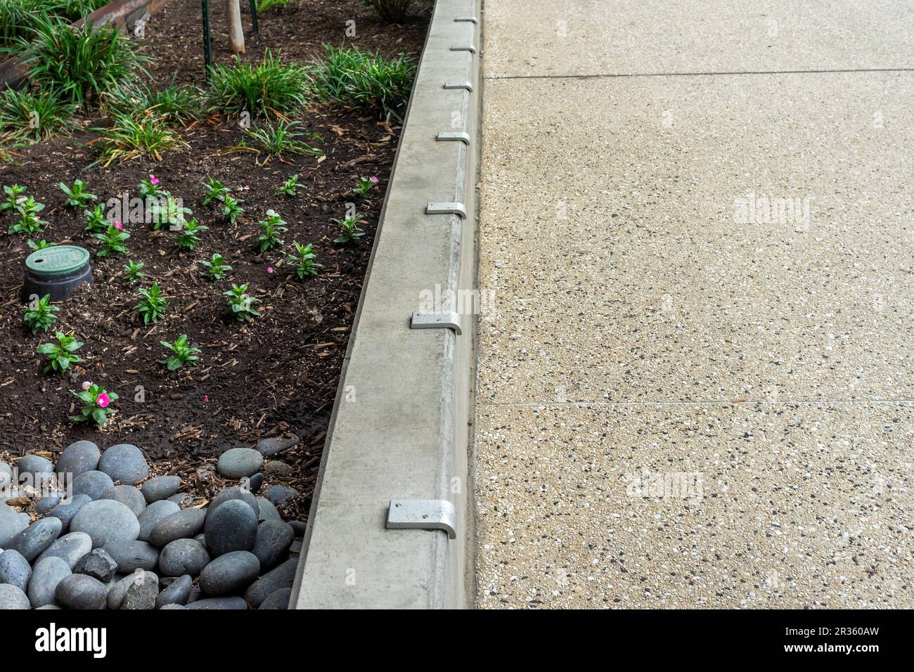 Metal skateboard deterrents placed on a concrete garden step in a ...