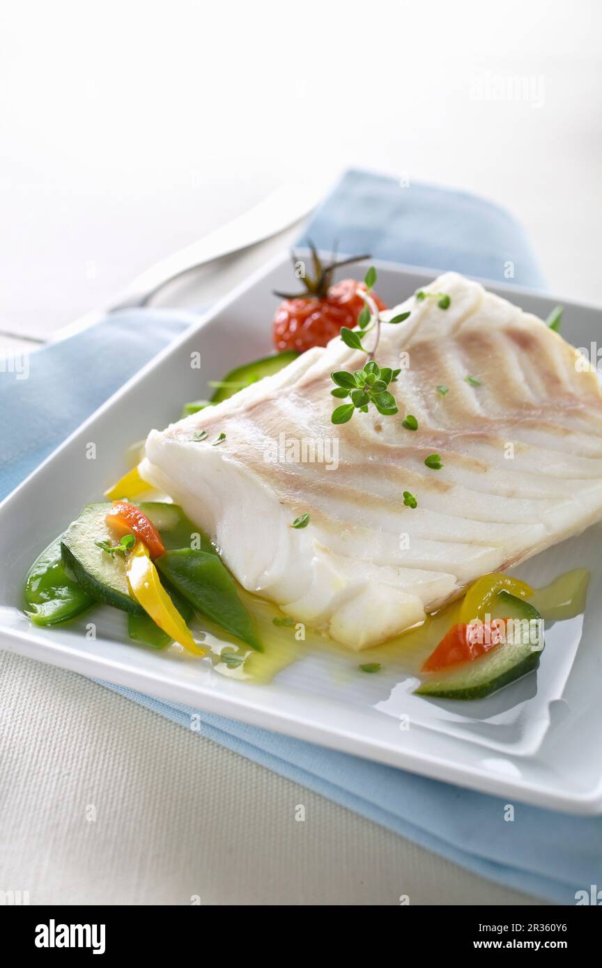 Cod fillet with spring vegetables Stock Photo - Alamy