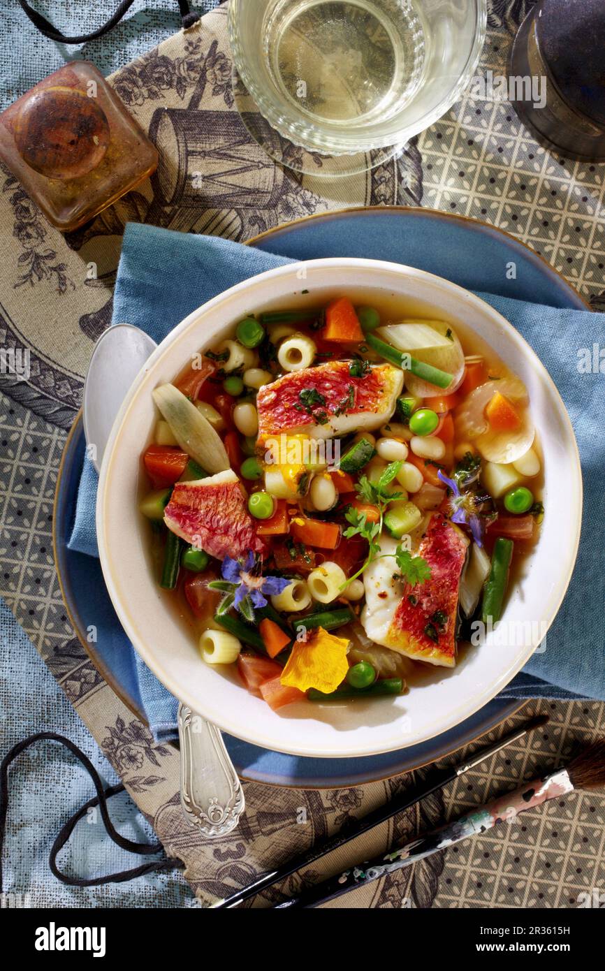 Colourful minestrone with red mullet and edible flowers Stock Photo - Alamy