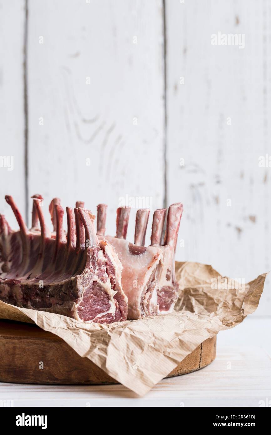 A raw rack of lamb on a piece of paper Stock Photo - Alamy