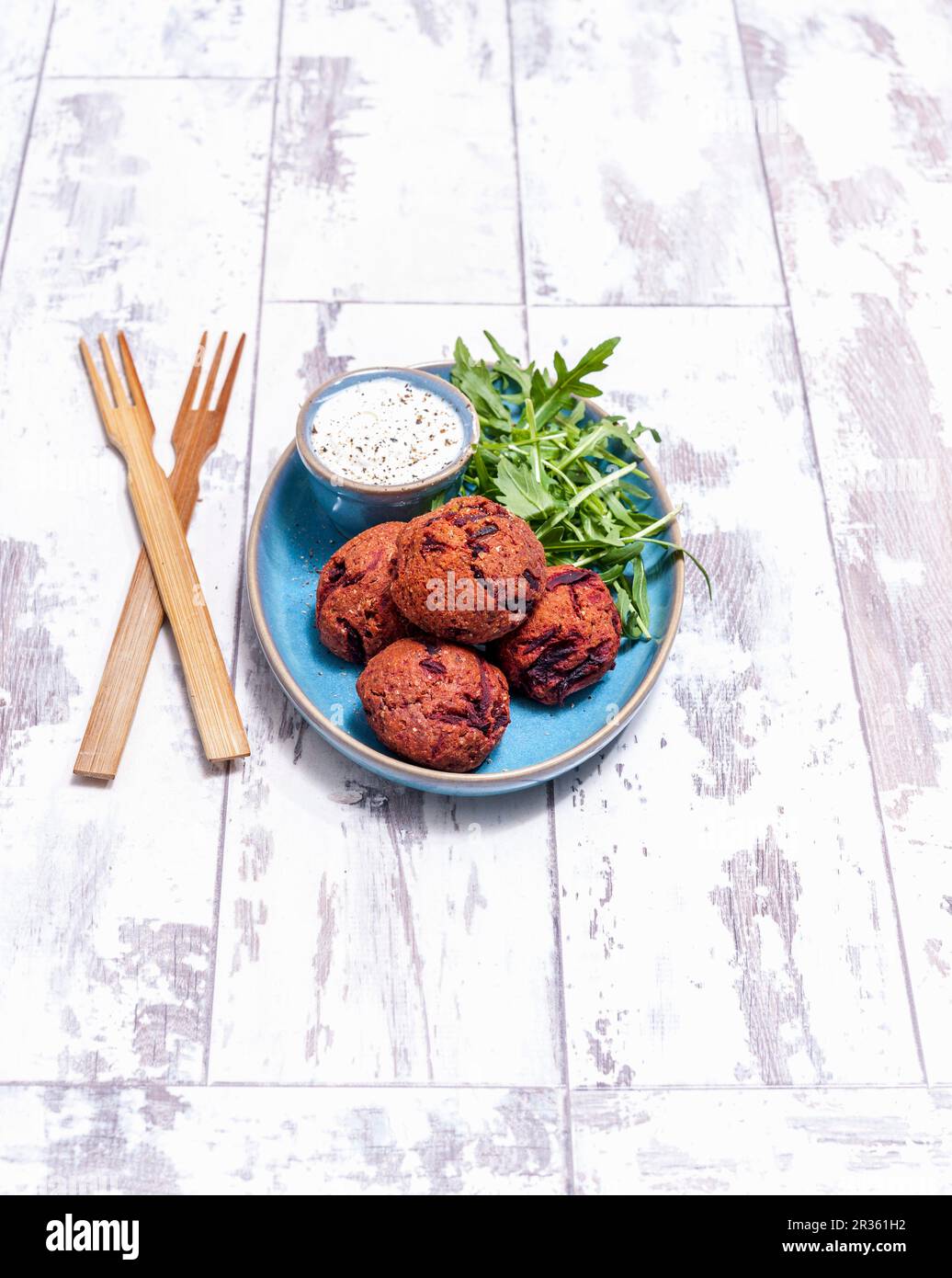 Beetroot falafel with yoghurt and rocket Stock Photo - Alamy