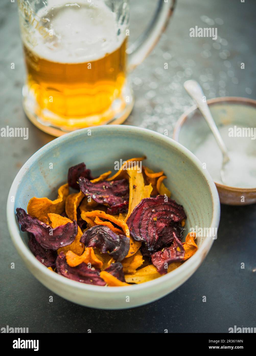 Colourful vegetable crisps (carrots, parsnips and beetroot) with salt ...