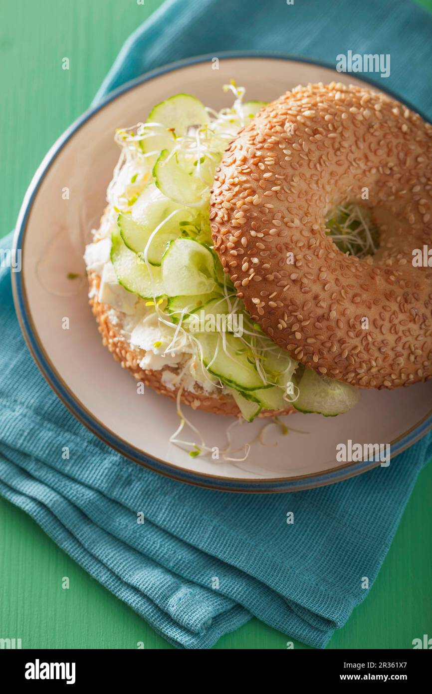 A bagel filled with cucumber, feta cheese and alfalfa sprouts Stock ...