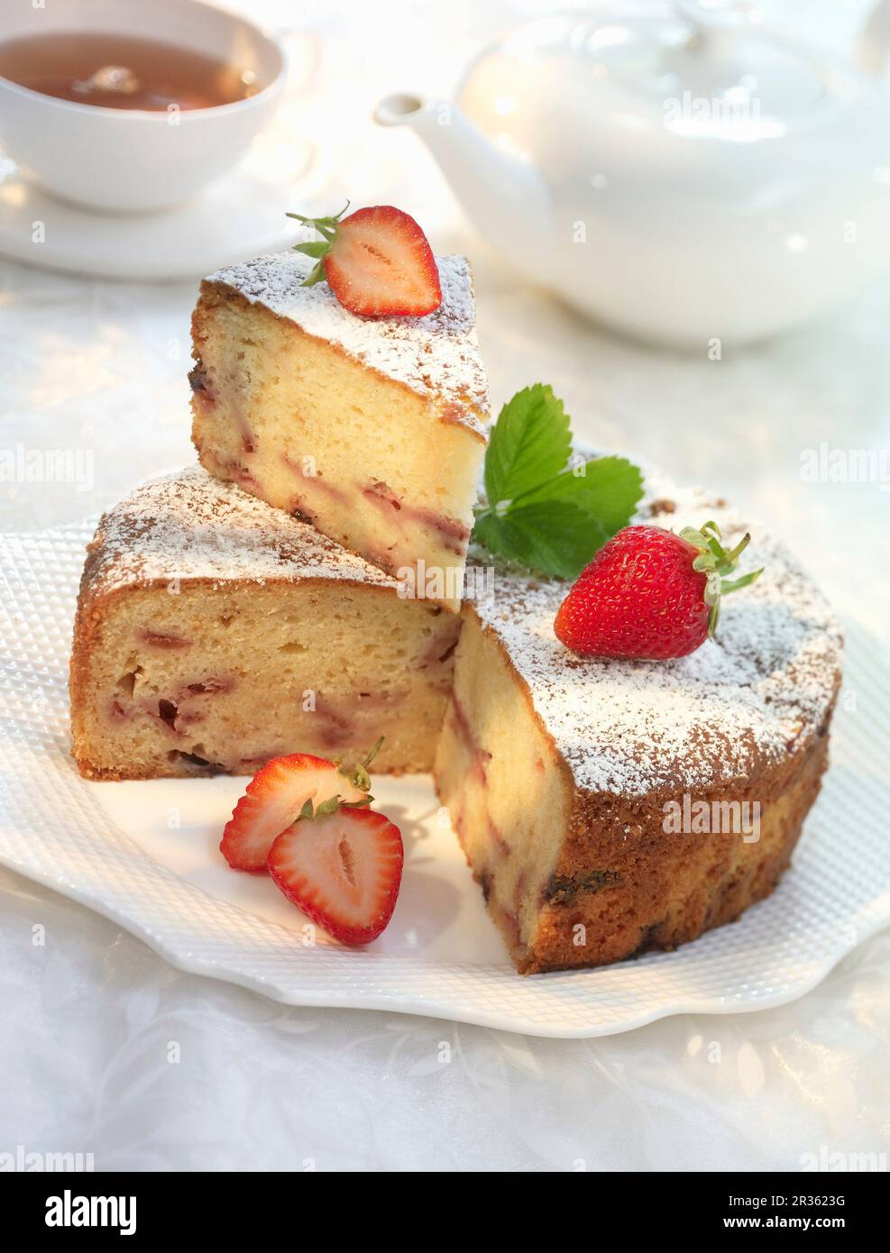 Madeira cake with strawberries and icing sugar, sliced Stock Photo - Alamy