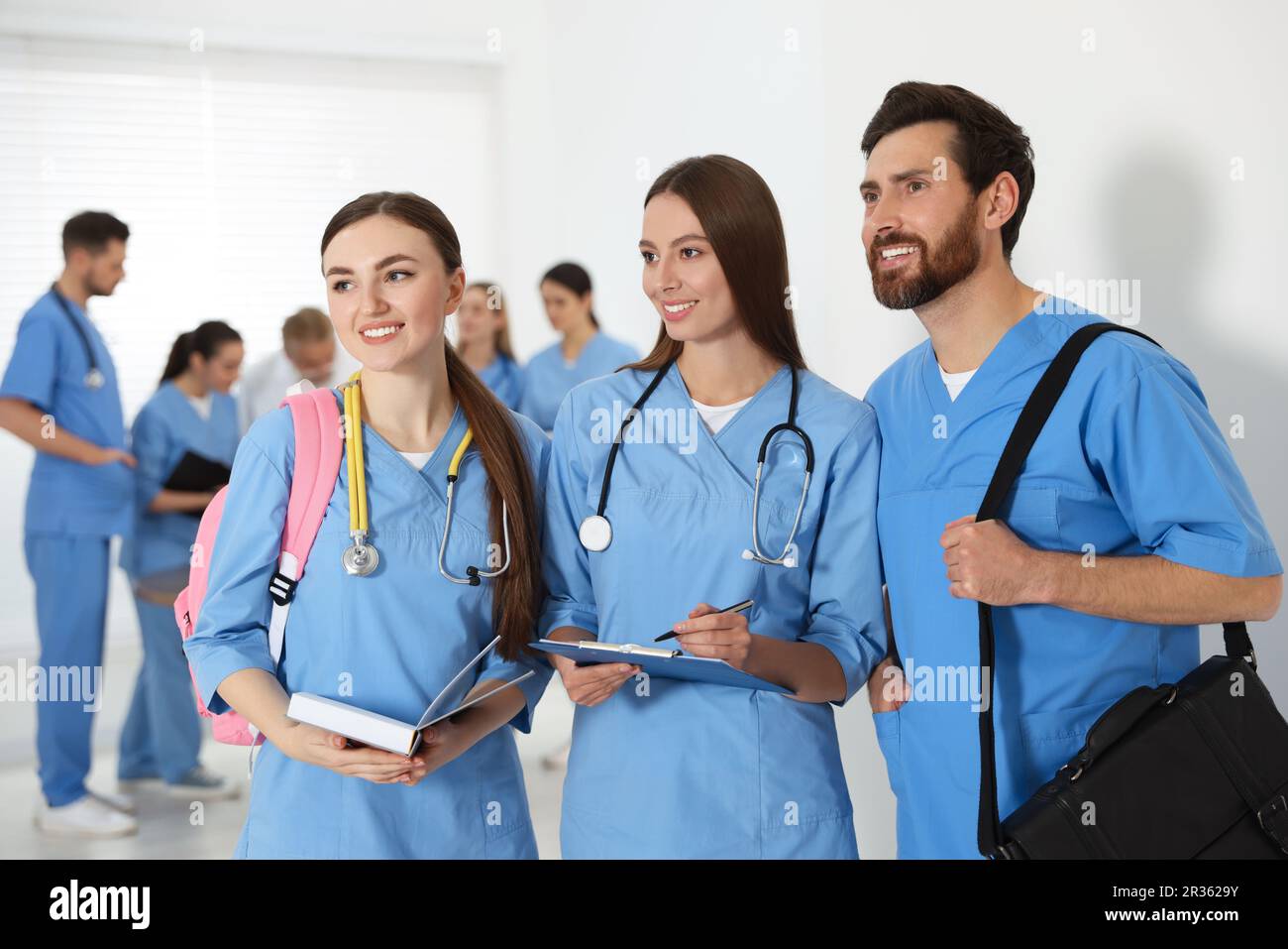 Medical students wearing uniforms in university hallway Stock Photo - Alamy