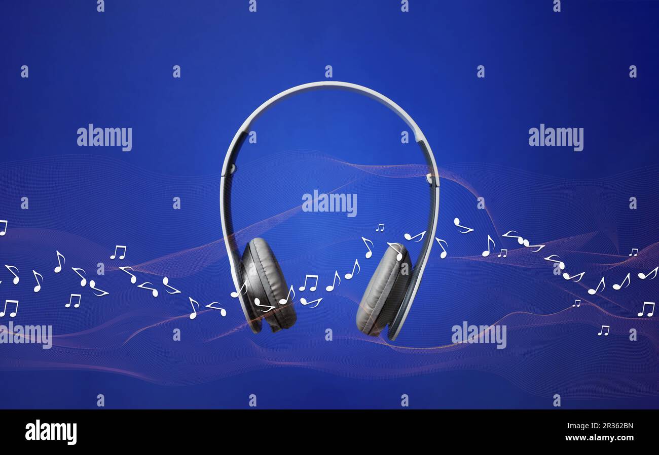Headphones and flow of music notes on blue background Stock Photo - Alamy