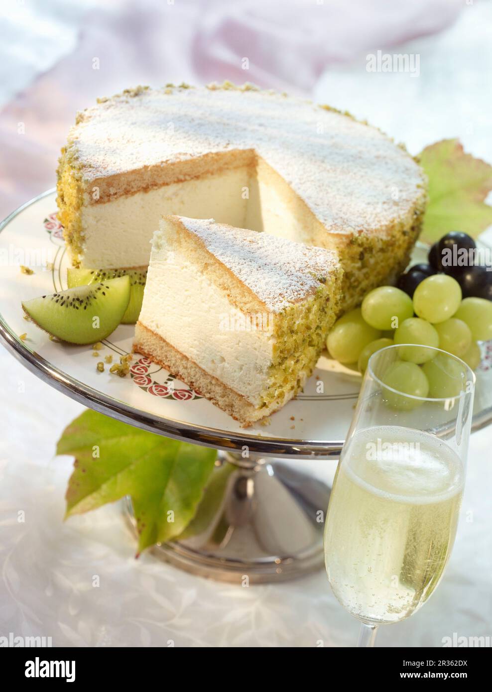 A creamy cheesecake garnished with kiwis and grapes Stock Photo - Alamy