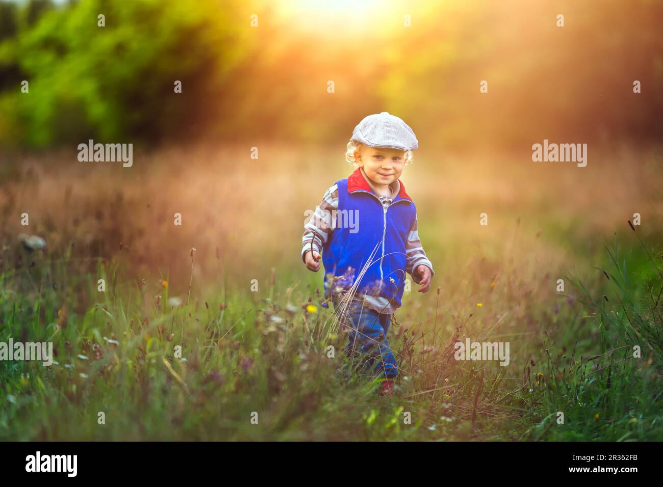 Little boy playing in nature. Caucasian boy and green landscape Stock ...