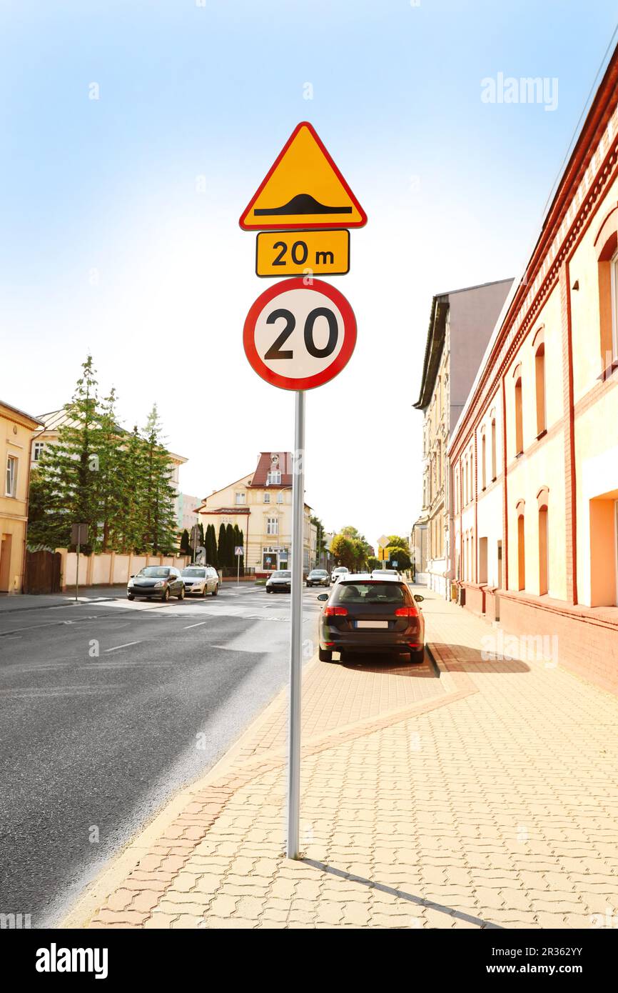 Post with different road signs on city street Stock Photo - Alamy