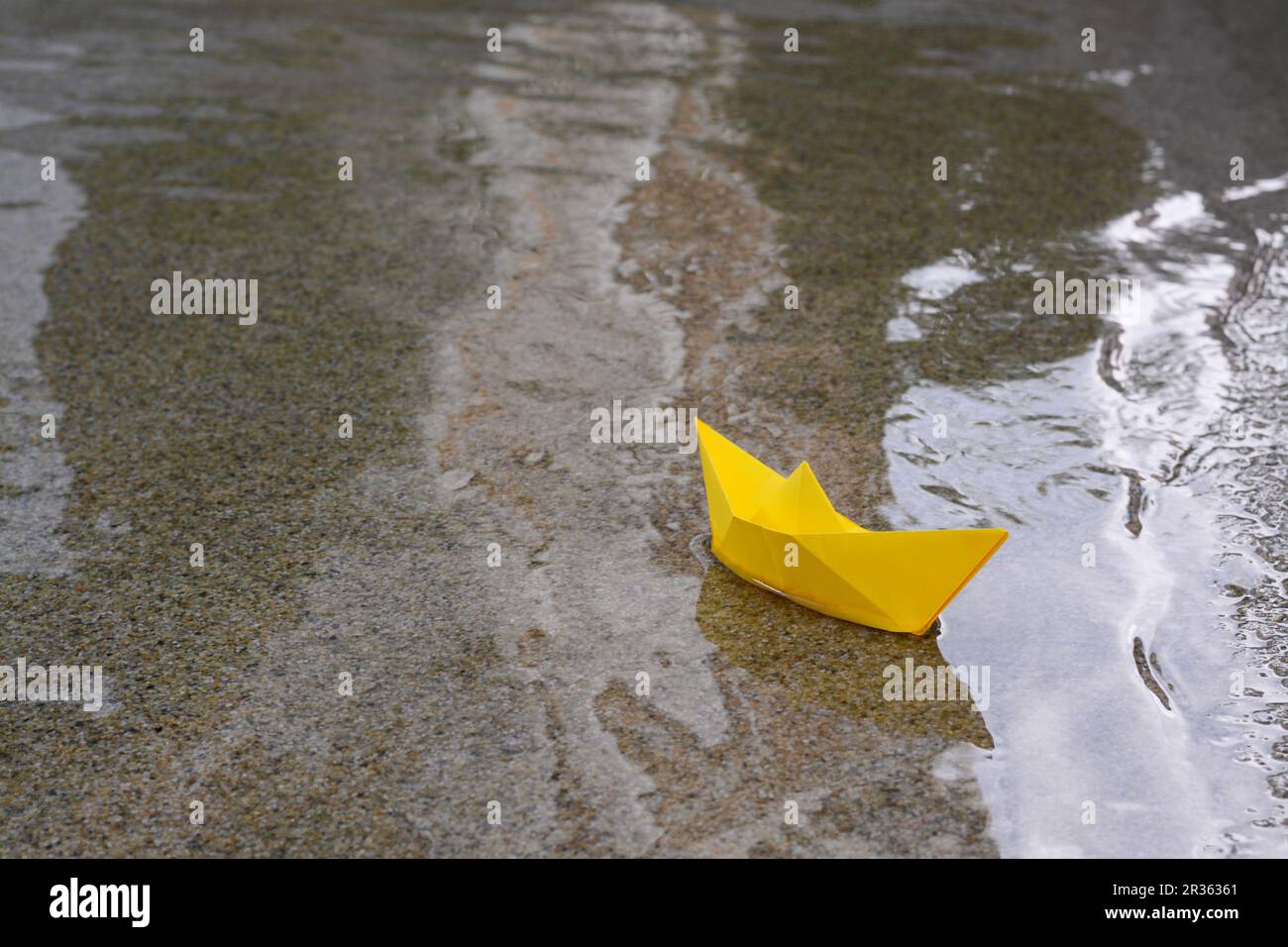 Beautiful yellow paper boat on water outdoors, space for text Stock ...