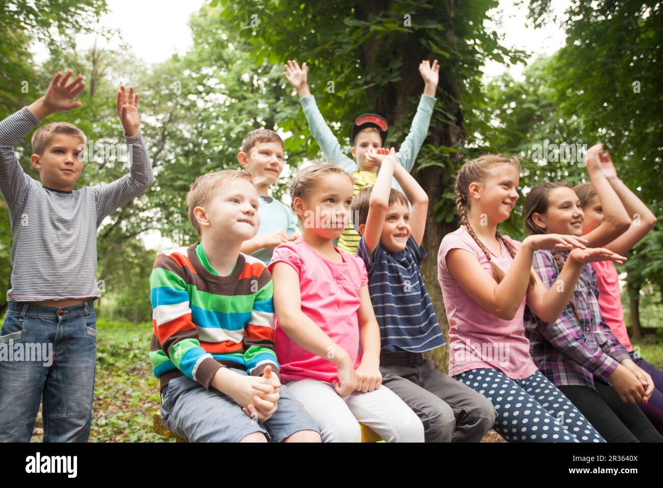 Group of children on a park bench Stock Photo - Alamy