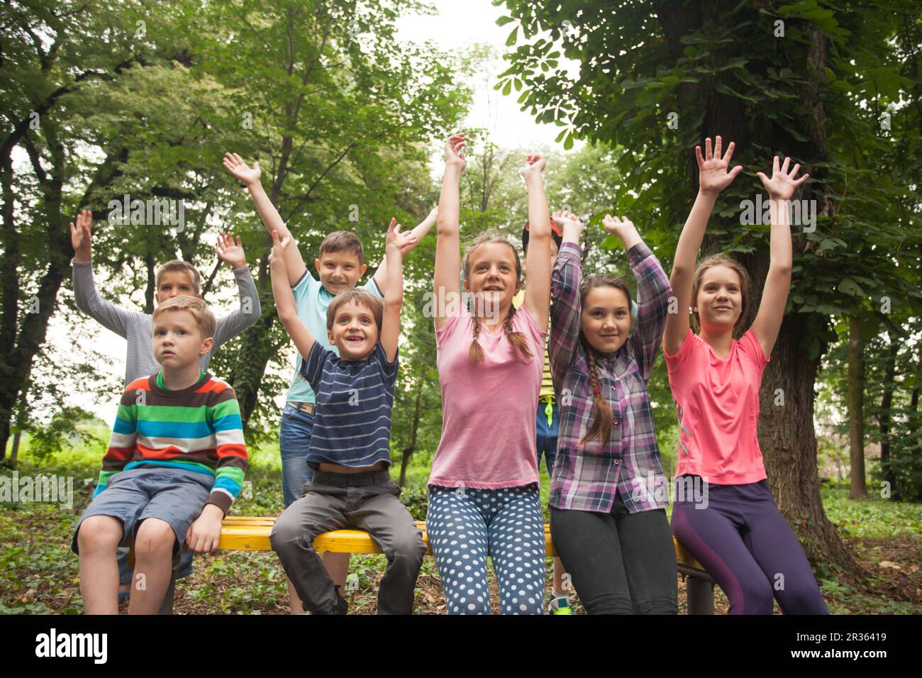 Group of children on a park bench Stock Photo - Alamy
