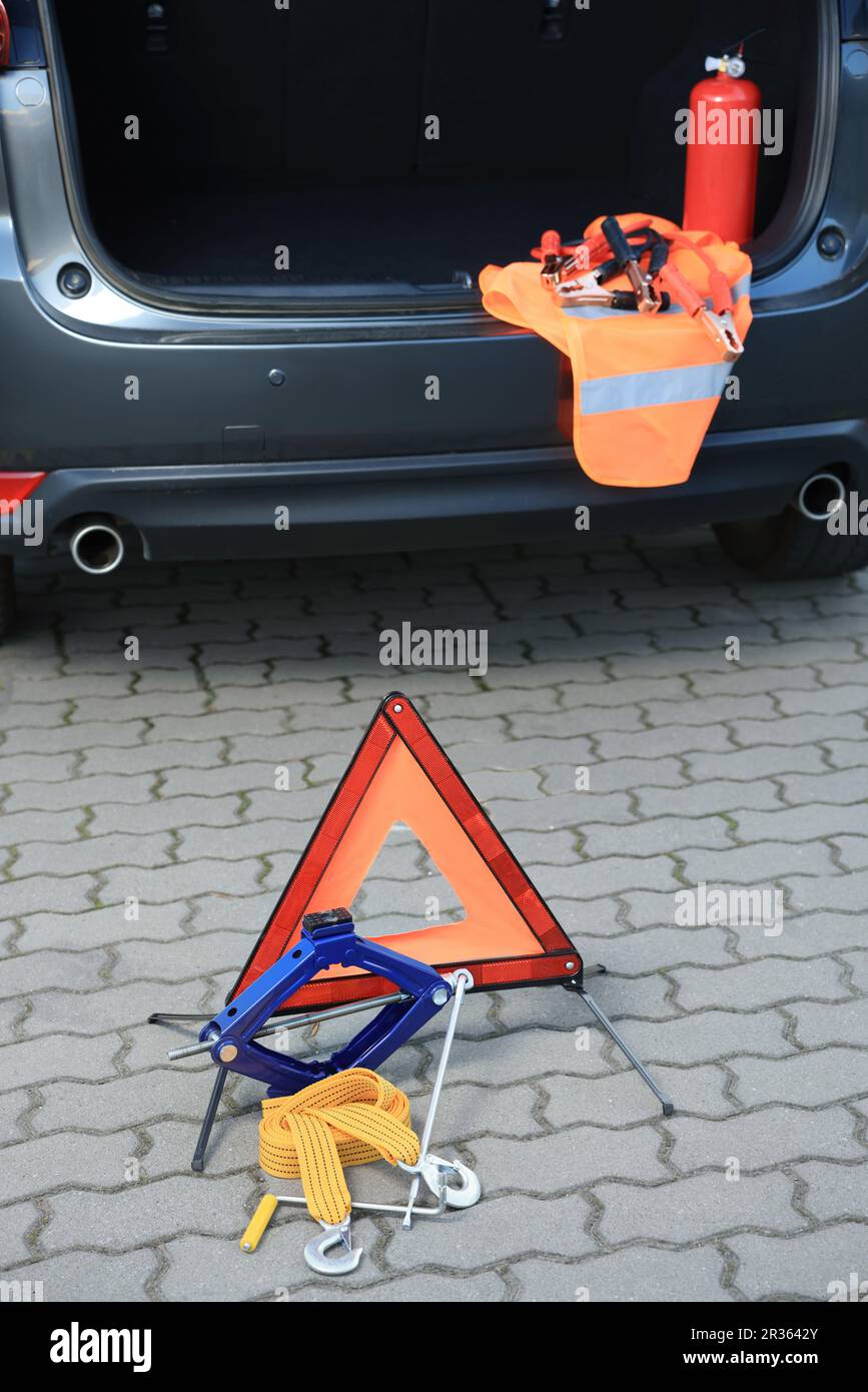 Emergency warning triangle and safety equipment near car Stock Photo ...