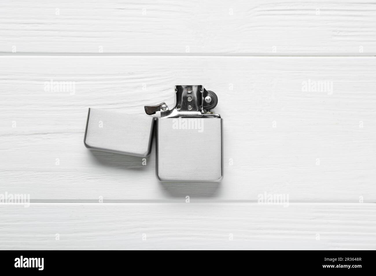 Gray metallic cigarette lighter on white wooden table, top view Stock ...