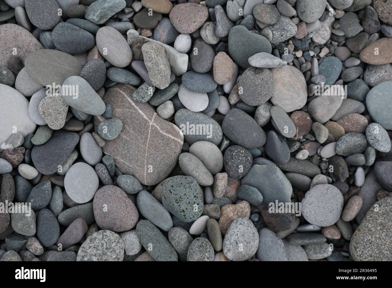 Many different pebbles as background, top view Stock Photo - Alamy