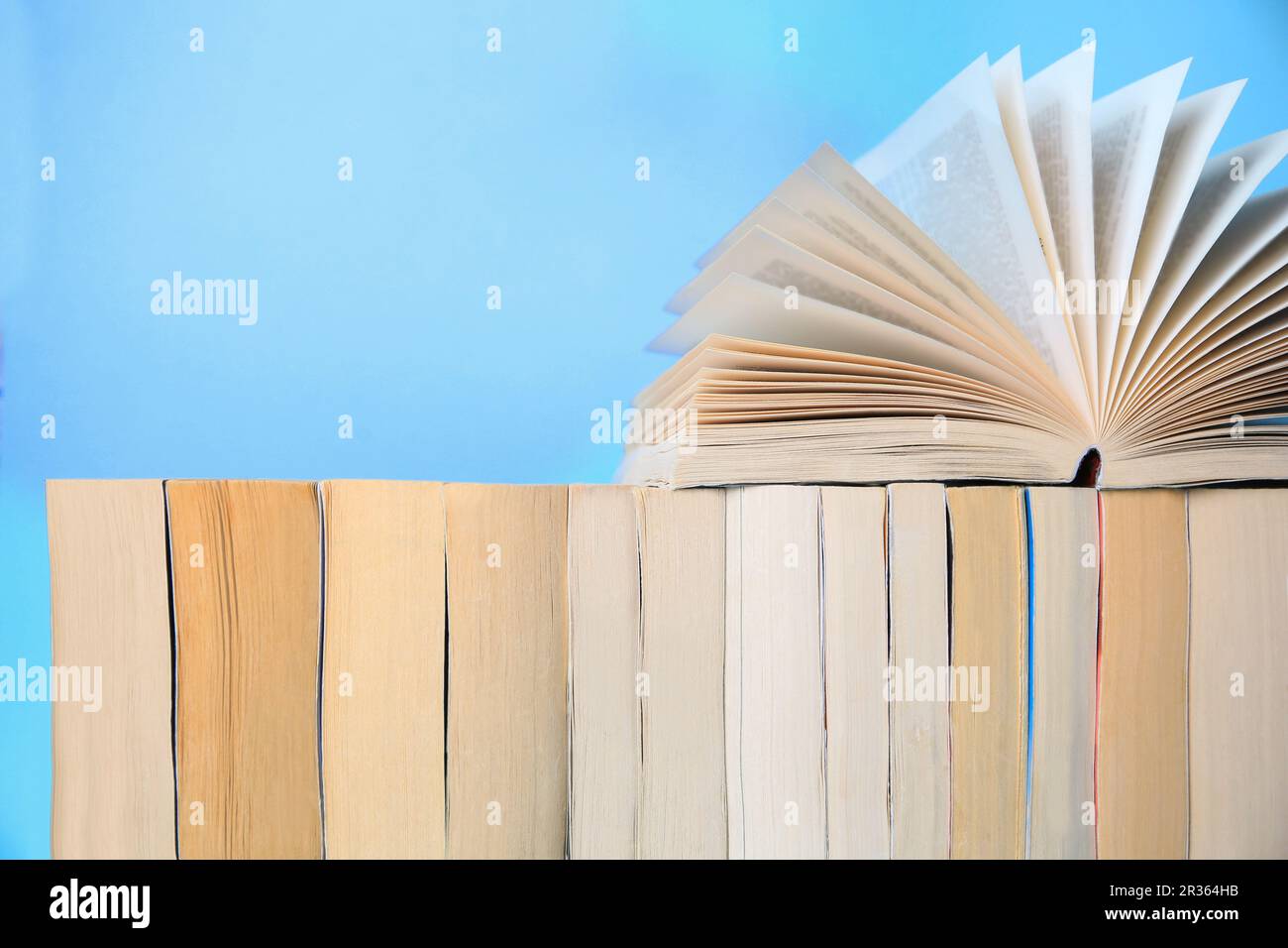 Collection of books on light blue background Stock Photo - Alamy