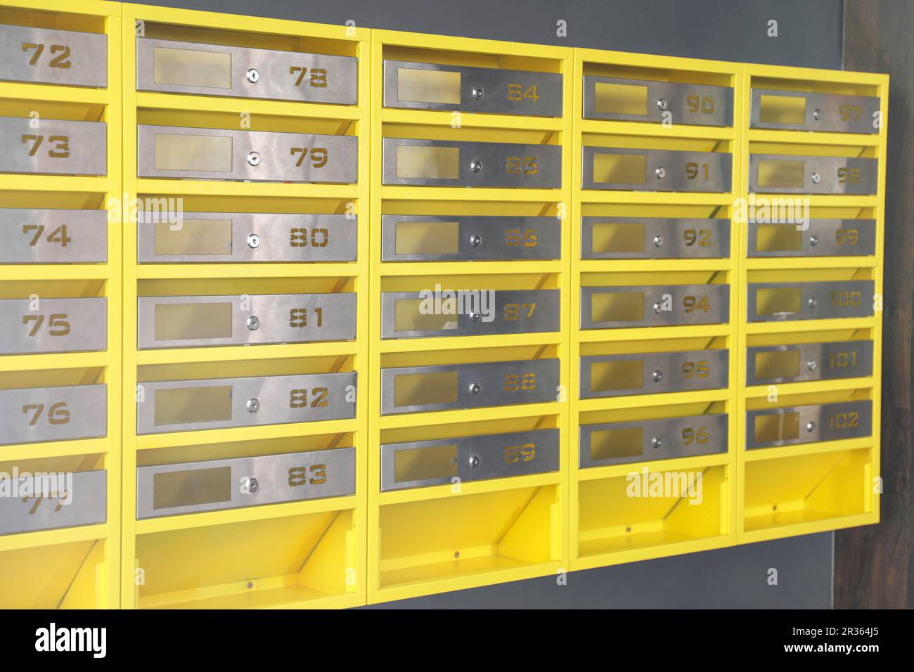 Many closed metal mailboxes with keyholes and numbers in post office ...