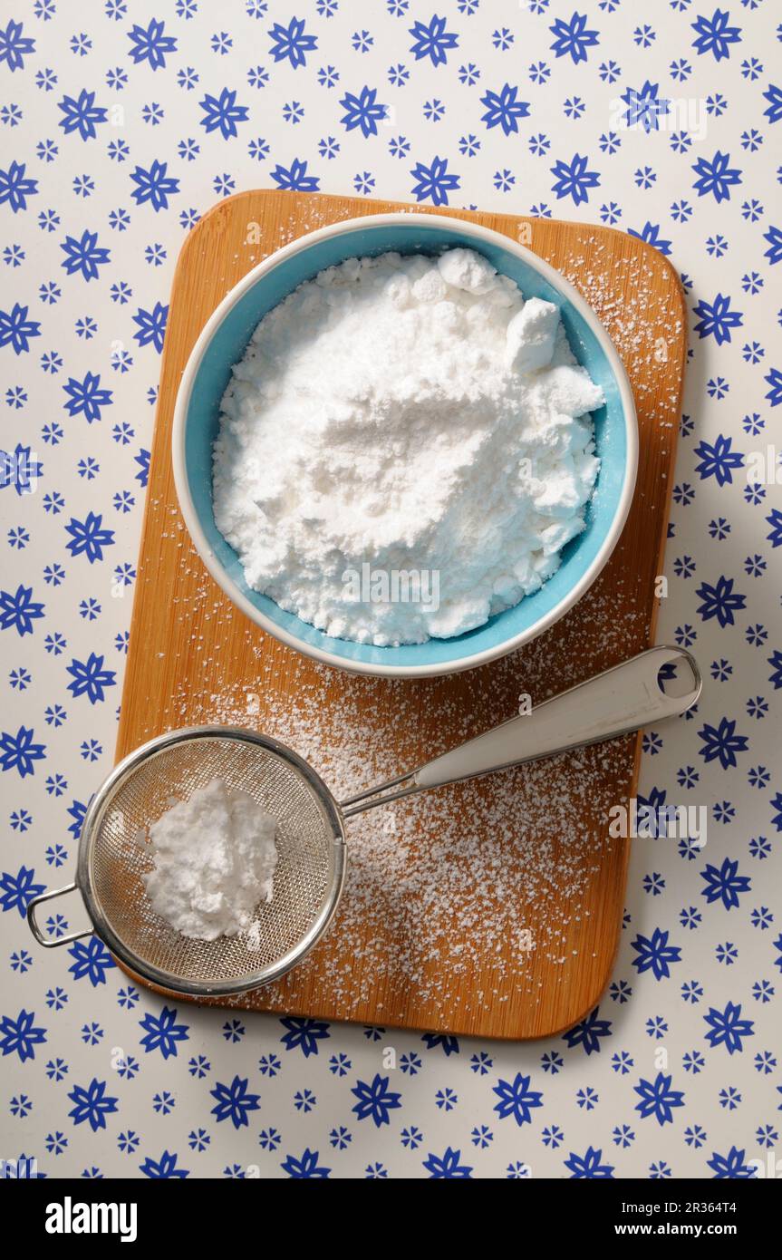 Icing sugar in a bowl and in a sieve hi-res stock photography and ...