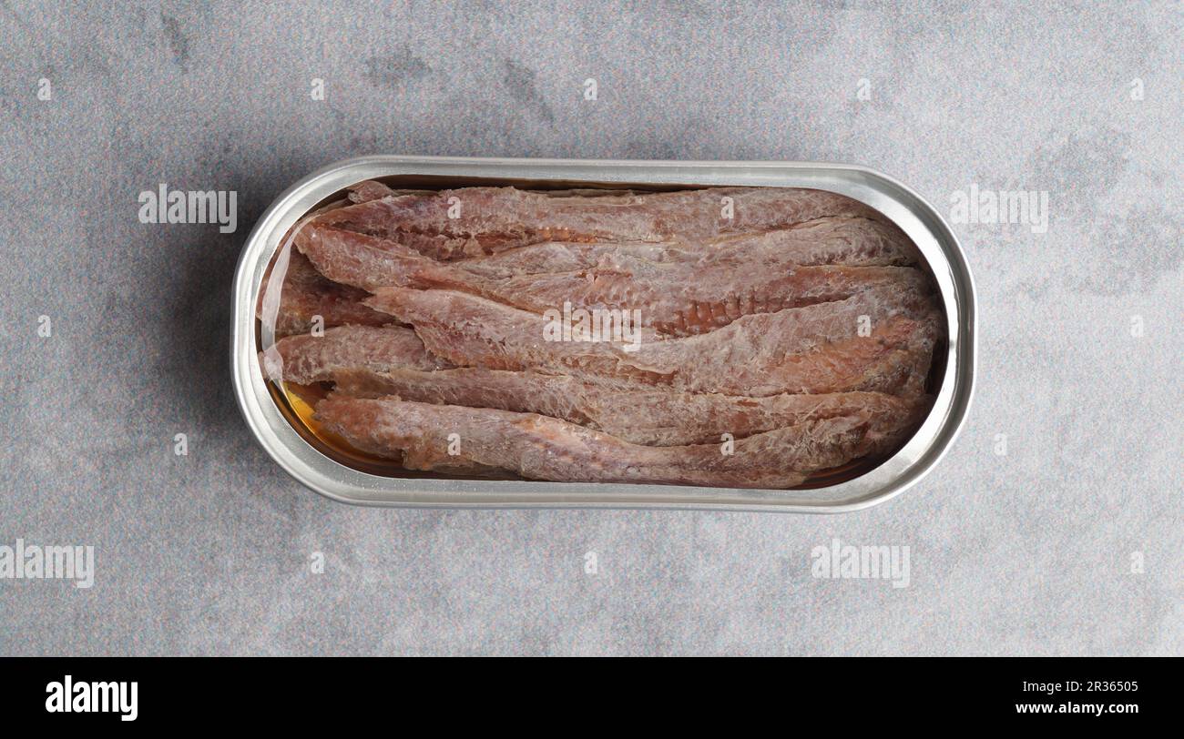 Canned anchovy fillets on light gray table, top view Stock Photo - Alamy
