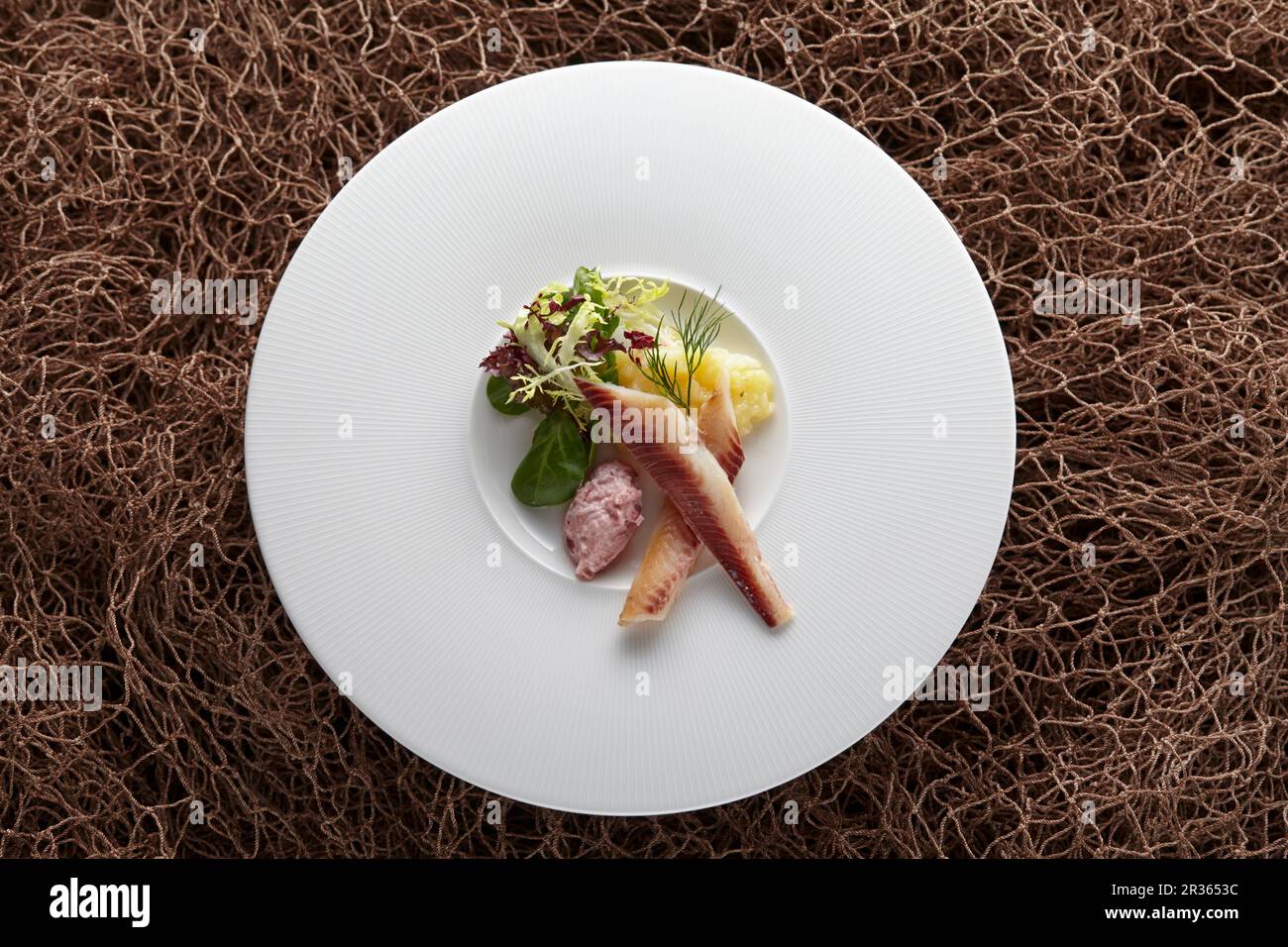 Smoked Lake Constance whitefish fillet on a potato salad with ...