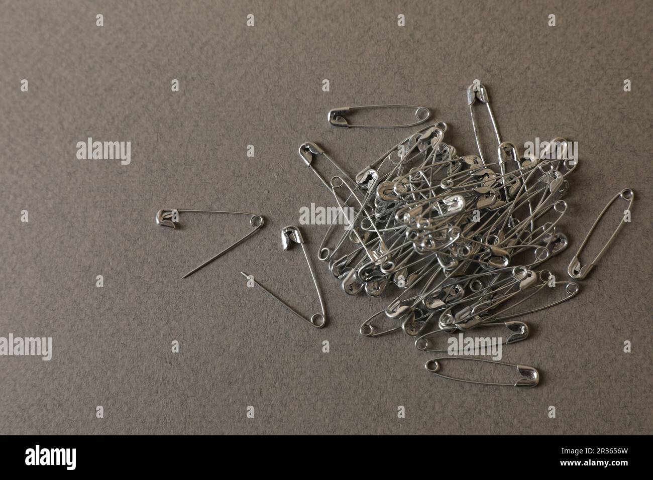 Pile of safety pins on grey textured background, flat lay Stock Photo ...