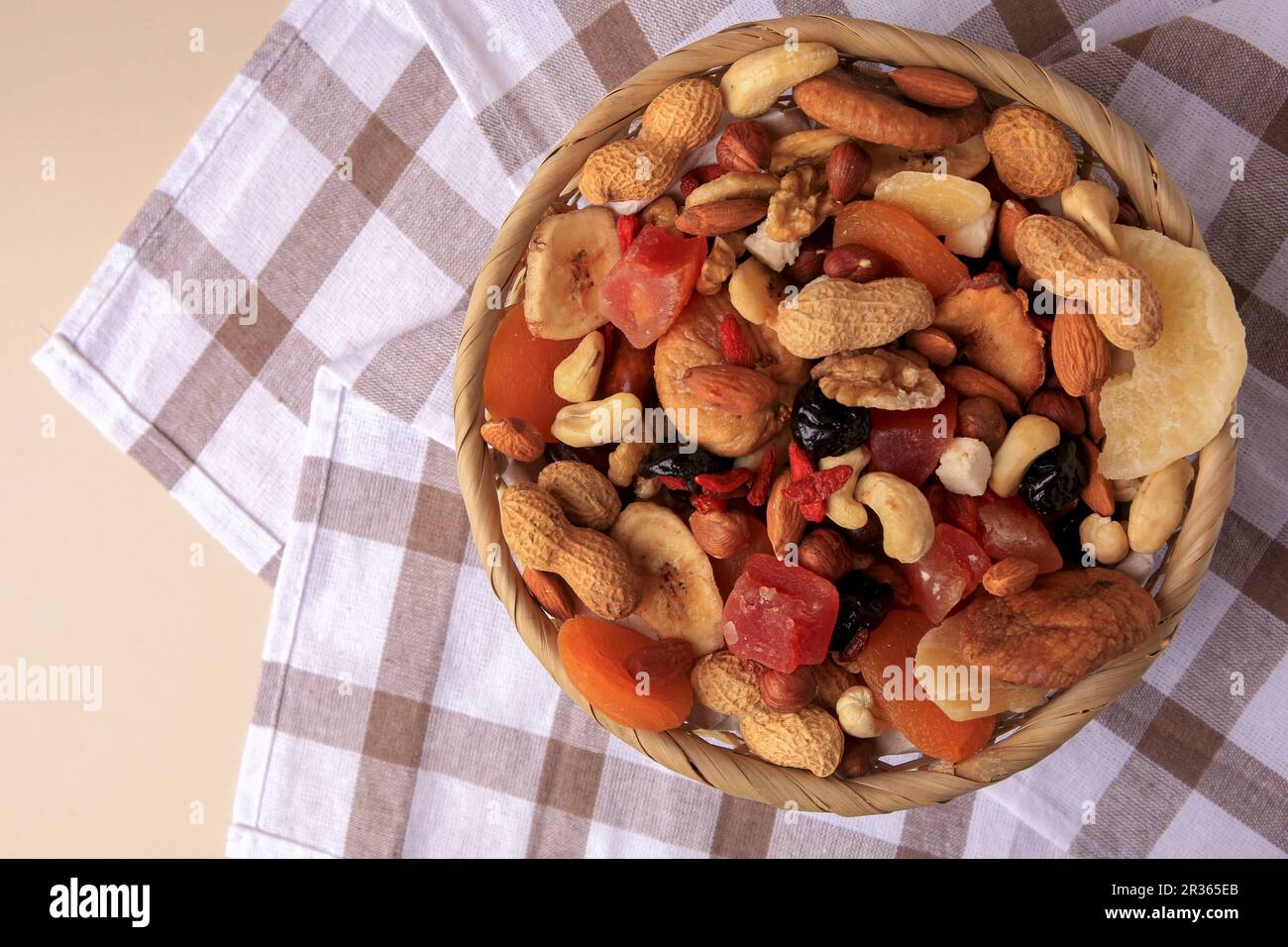 Mixed dried fruits and nuts on beige background, top view. Space for text Stock Photo - Alamy