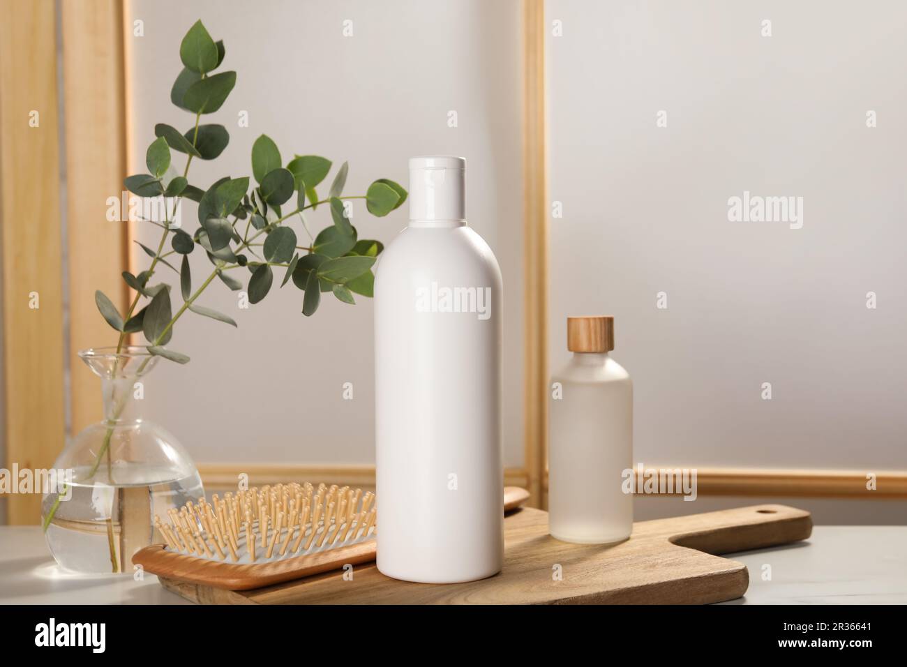 Bottles of shampoo and hairbrush on white table Stock Photo - Alamy