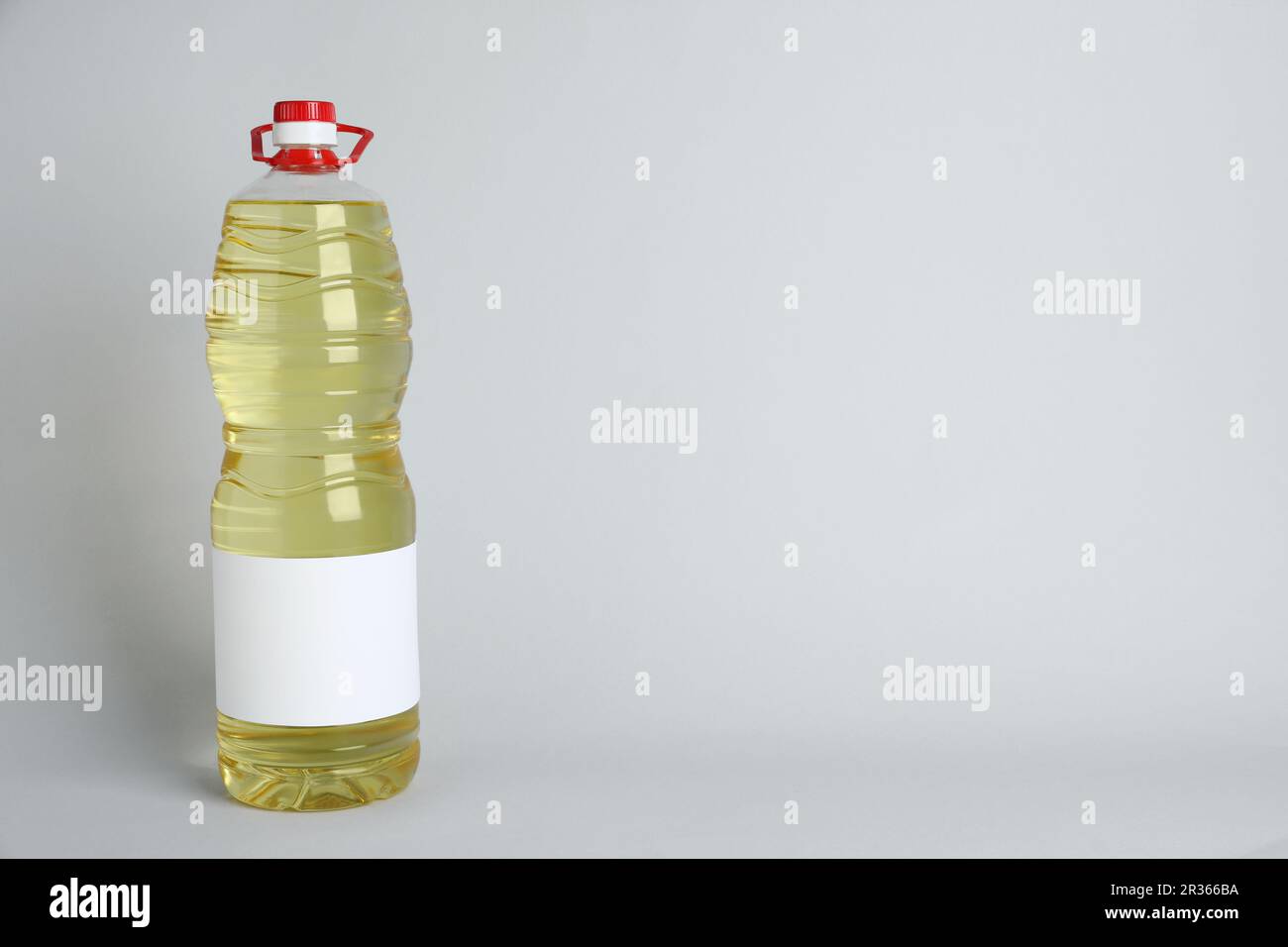 Bottle of cooking oil on light grey background. Space for text Stock ...