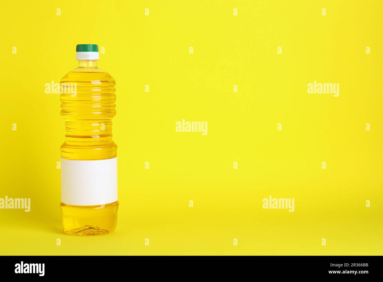 Bottle of cooking oil on yellow background. Space for text Stock Photo ...
