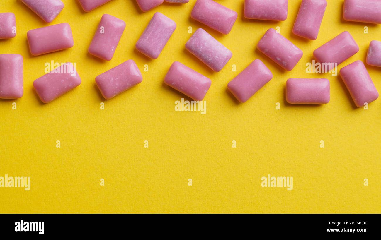 Sweet chewing gums on yellow background, flat lay. Space for text Stock ...