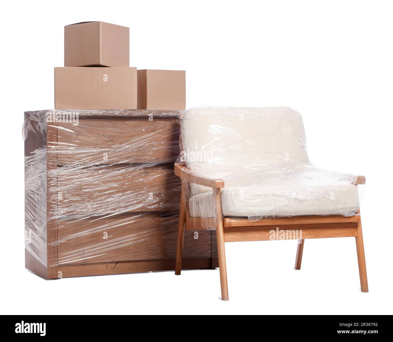 Boxes, armchair and chest of drawers wrapped in stretch film on white ...