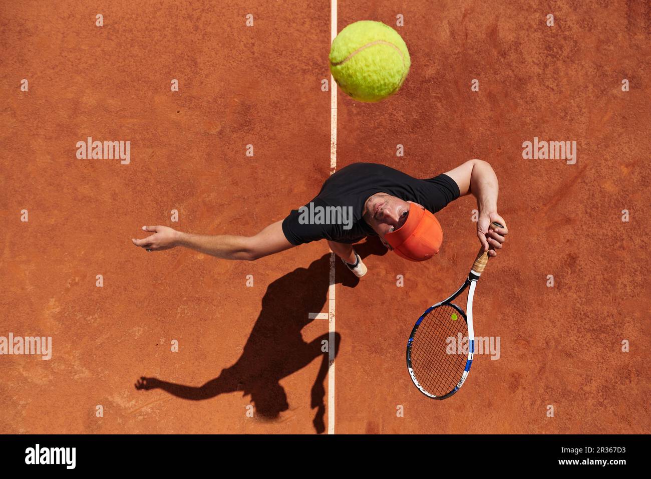 Top view of a professional tennis player serves the tennis ball on the ...
