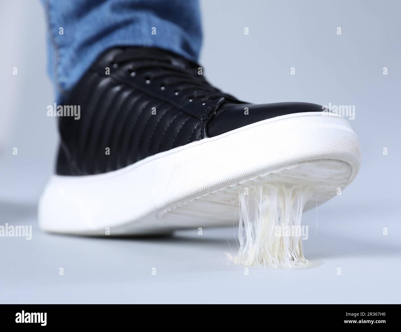 Man stepping into chewing gum on light grey background, closeup Stock ...