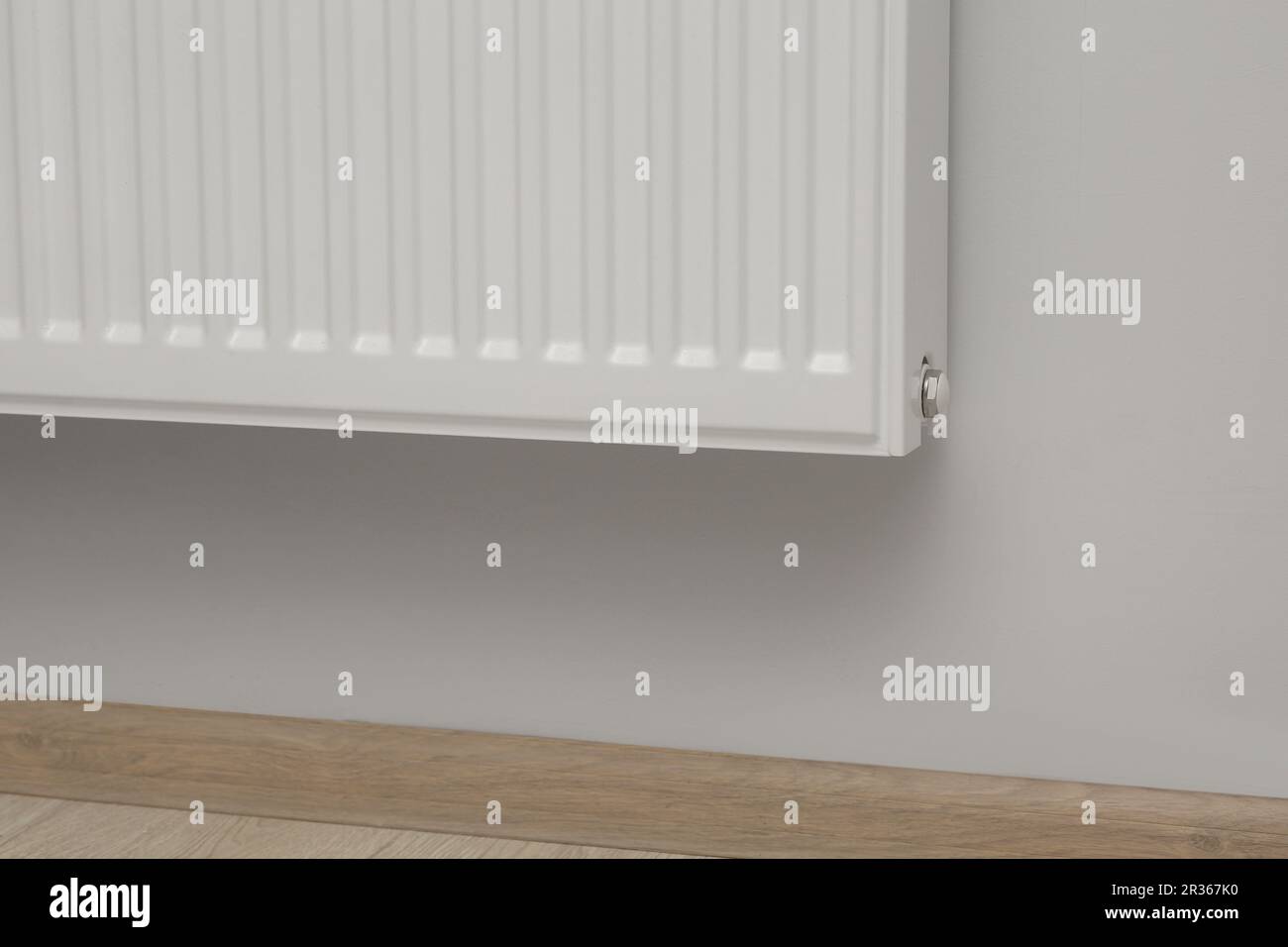 White wall with modern panel radiator indoors. Heating system Stock ...