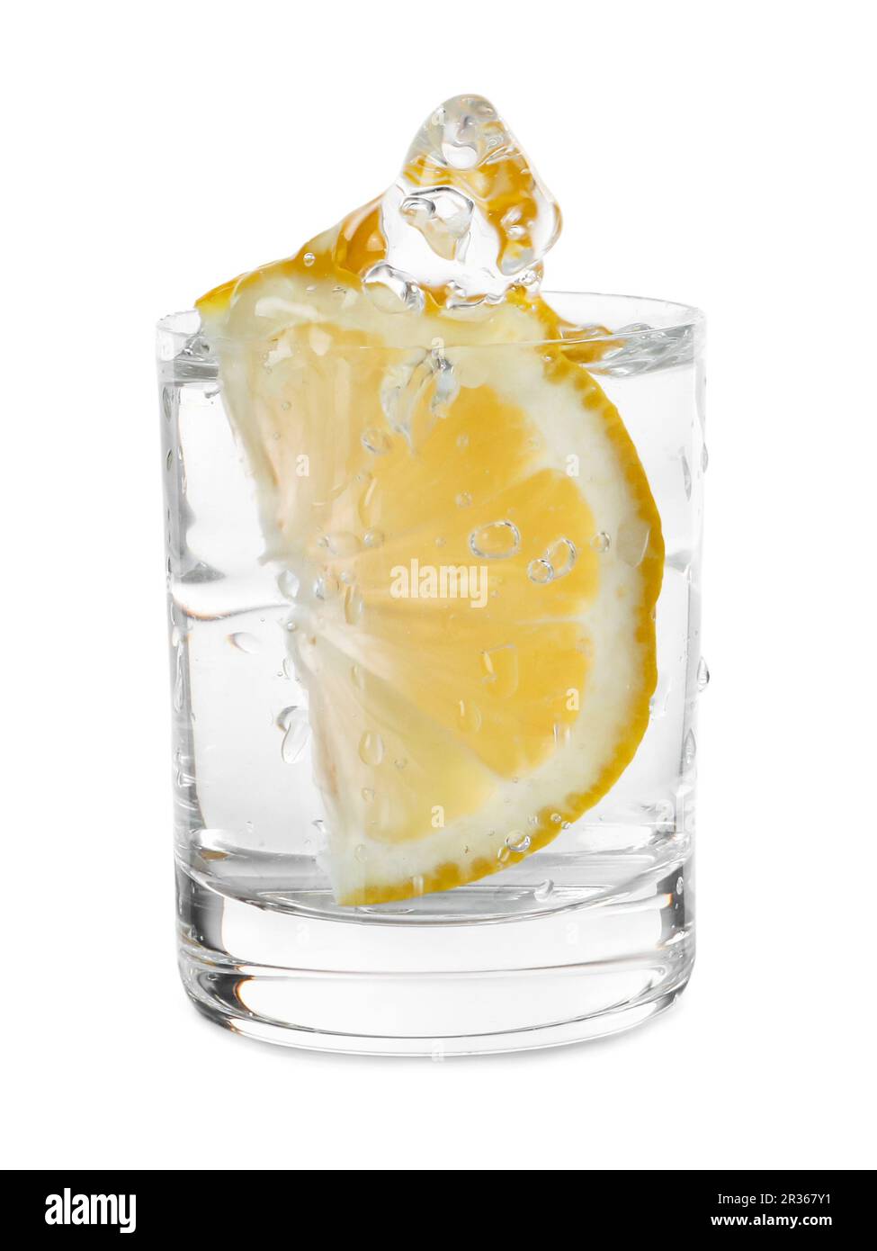 Vodka splashing out of shot glass with lemon on white background Stock ...