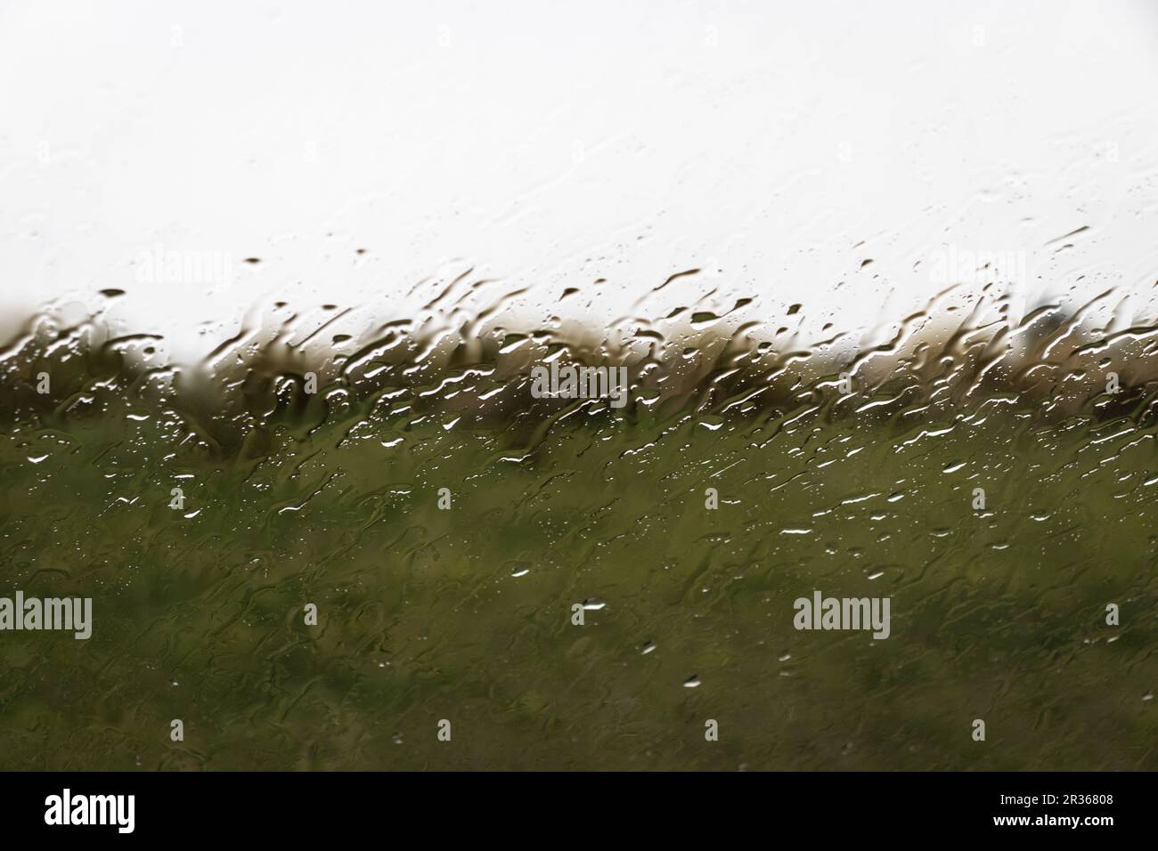 Abstract landscape image of outside on a rainy day viewed through a ...