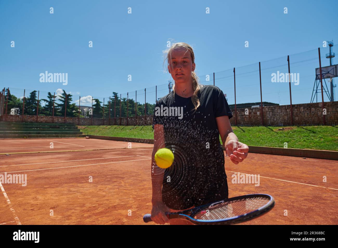 Before her training, the tennis player joyfully playing with a tennis ...