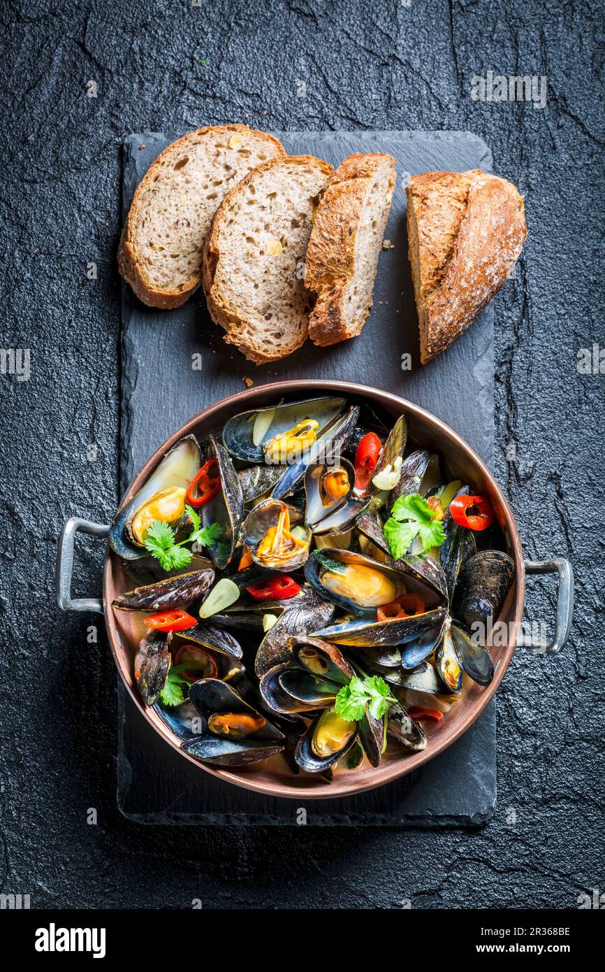 Roasted mussels with garlic served with bread Stock Photo - Alamy