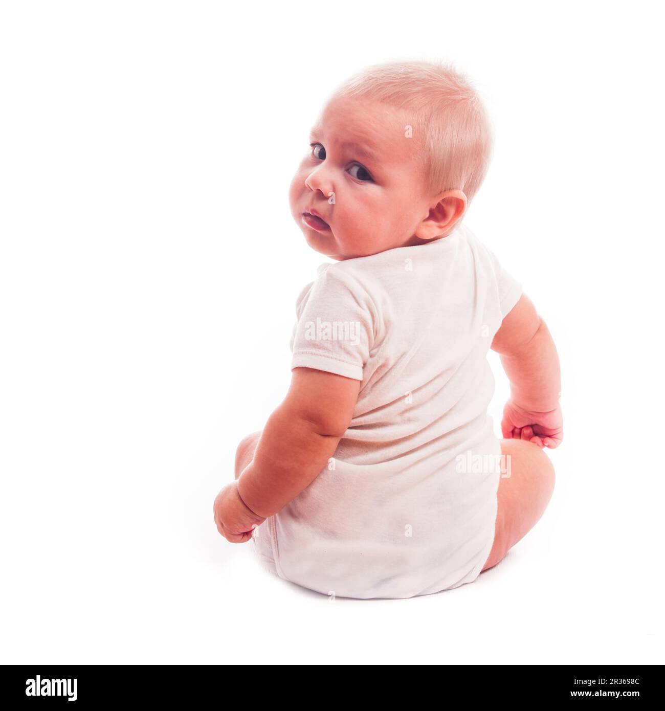 Baby looks over his shoulder Stock Photo - Alamy