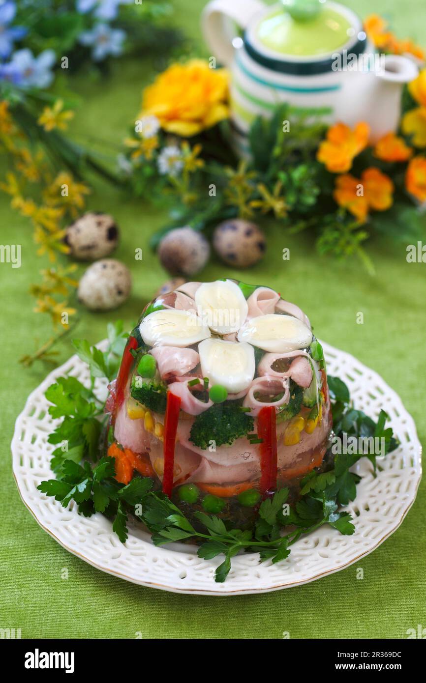 Quail's eggs, vegetables and ham in aspic for Easter Stock Photo - Alamy